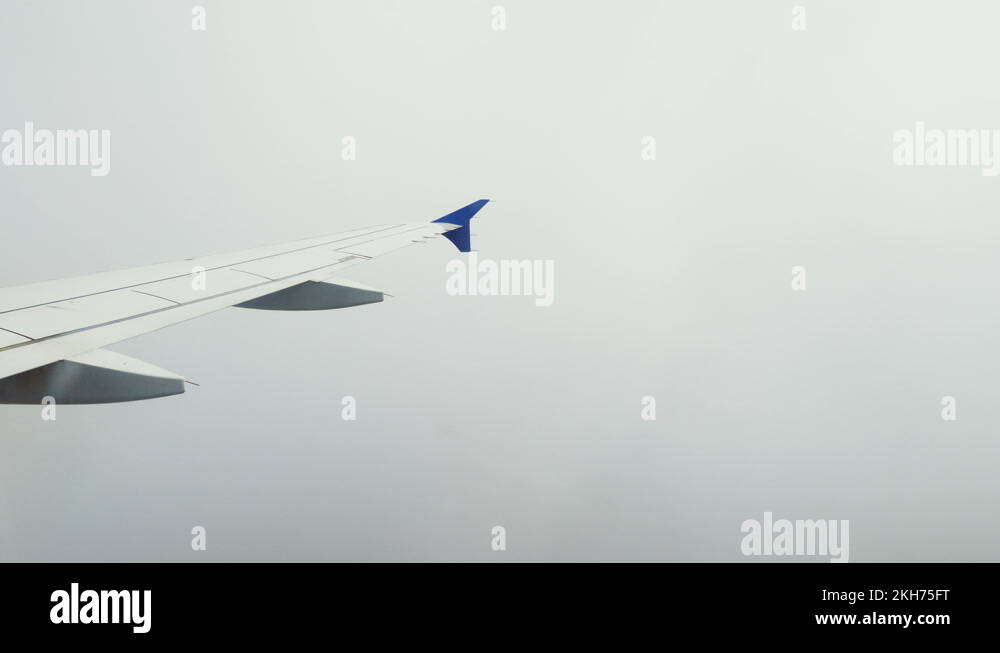 Aeroplane. View of airplane wing of aircraft flying above the clouds ...