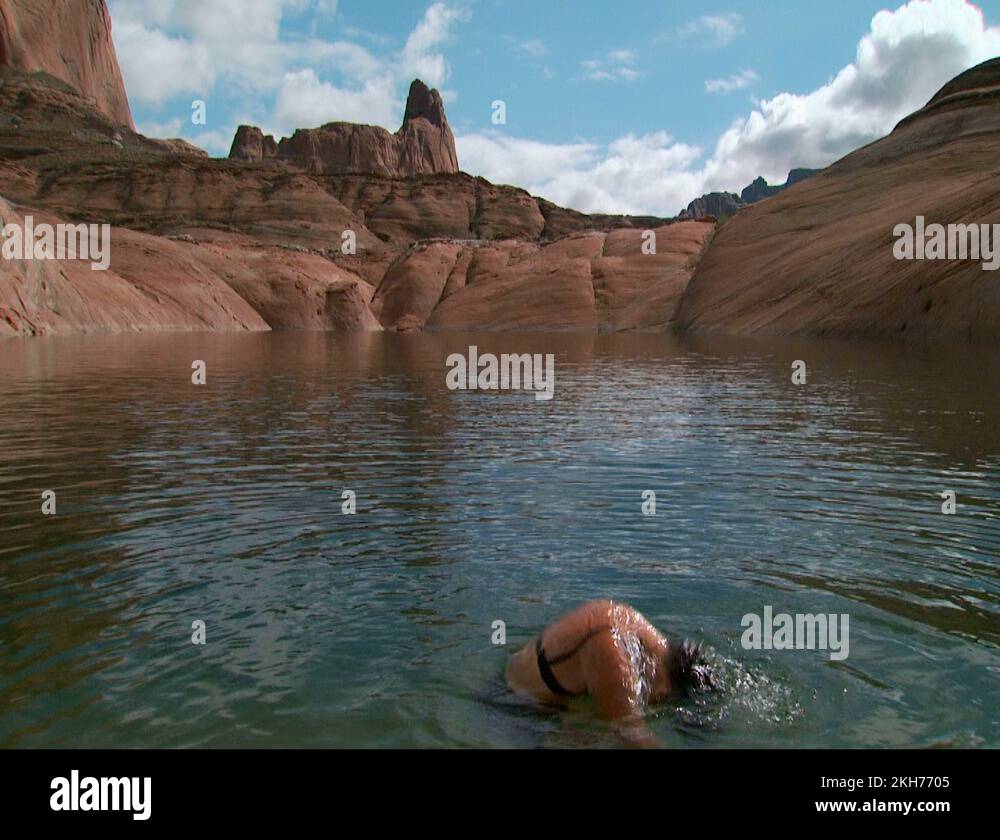 Woman emerging from body of water with splash Stock Video Footage - Alamy