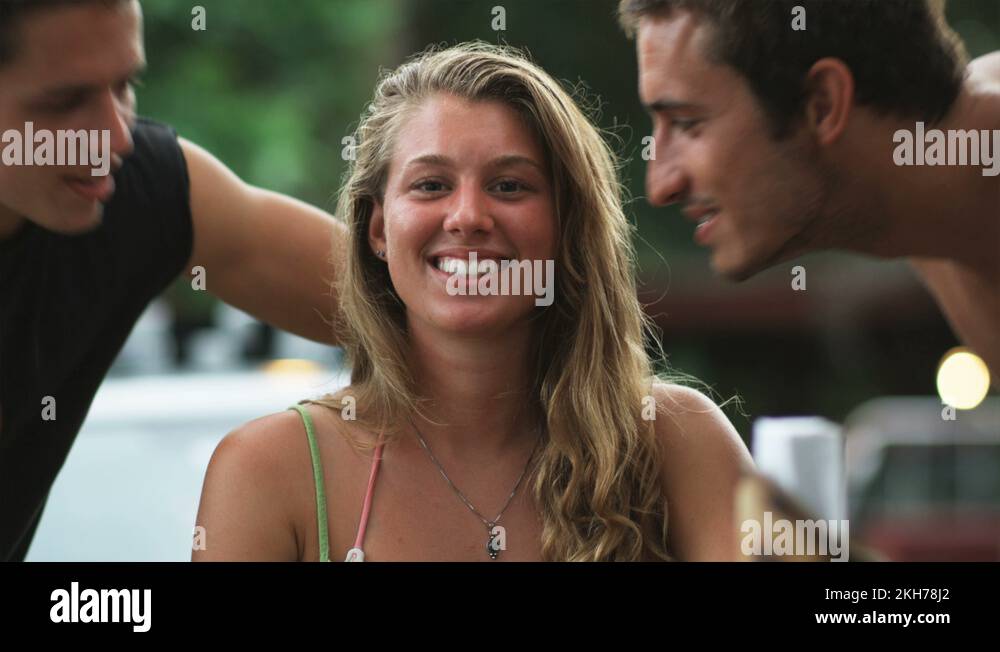 two men kissing the same girl as she looks at the camera Stock Video ...