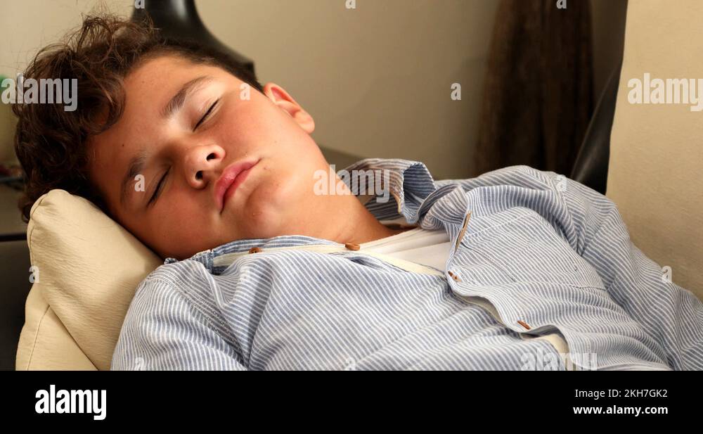 Teenage boy sleeping on sofa at home Stock Video Footage - Alamy
