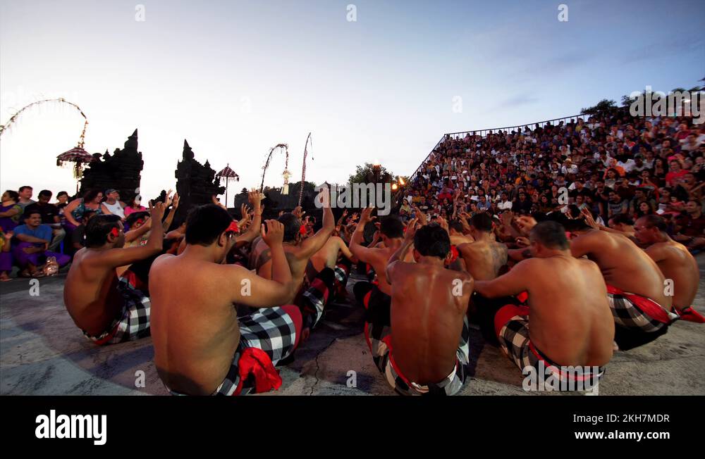 Shirtless indonesian men perform Kecak dance by shaking hands in circle ...