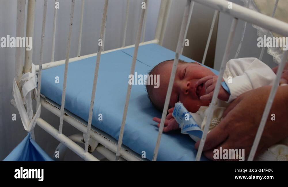 Mother Picks Up Her Newborn Baby From the Crib After Giving Birth ...