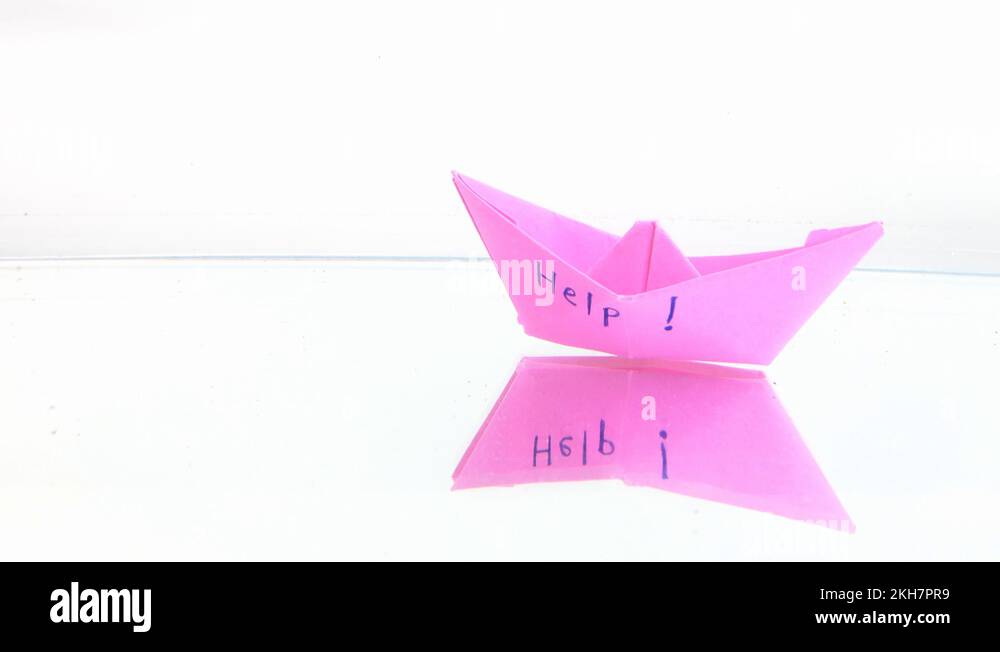 Sinking folded paper boat into the water. Mental state and Emotional ...