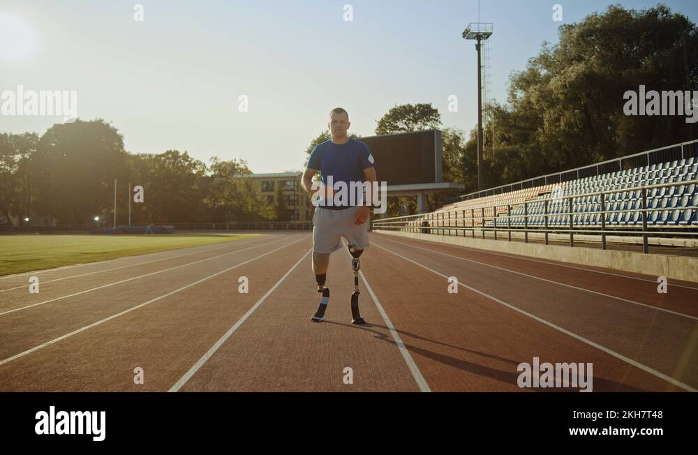 Athletic Disabled Fit Man with Prosthetic Running Blades Poses with ...