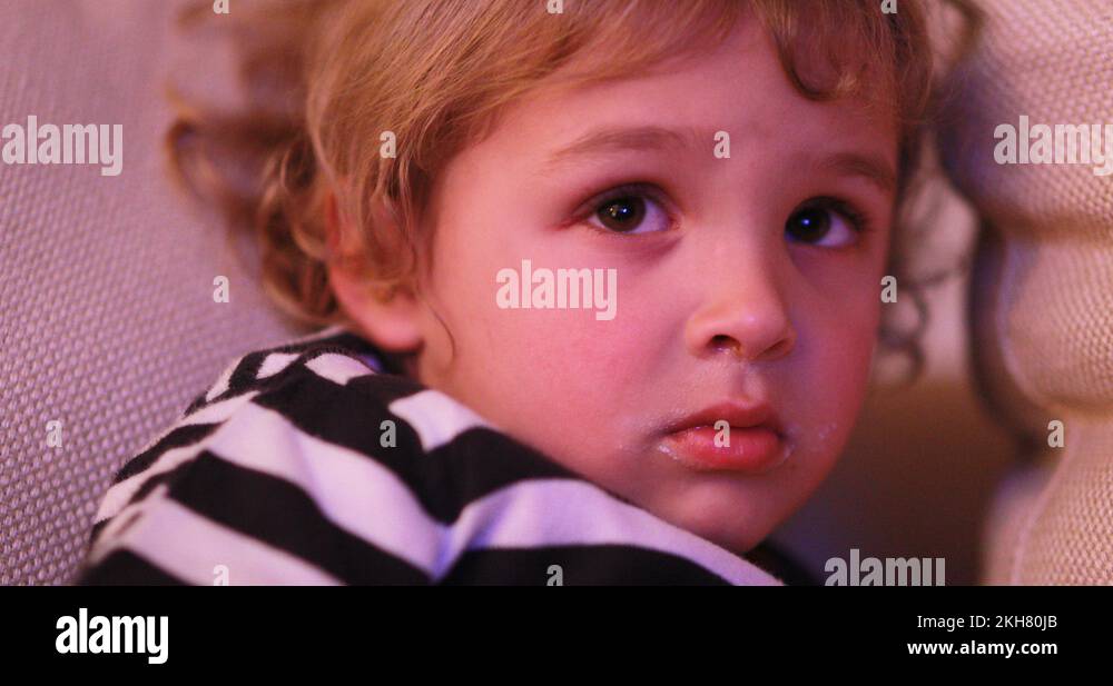 Child watching TV screen, close-up of toddler face hypnotized by ...