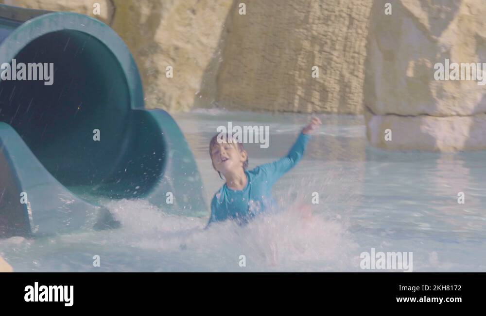 Little Boy Slides Down Water Slide at Resort Waterpark Stock Video ...