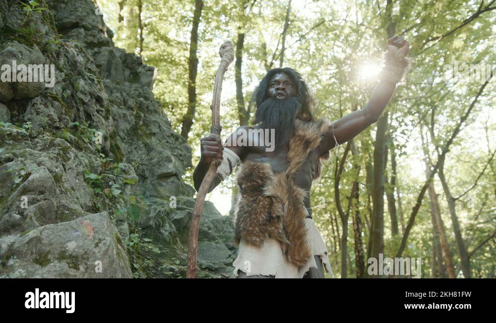 Prehistoric afro tarzan wildman of hunter-gatherers tribe in rocks ...