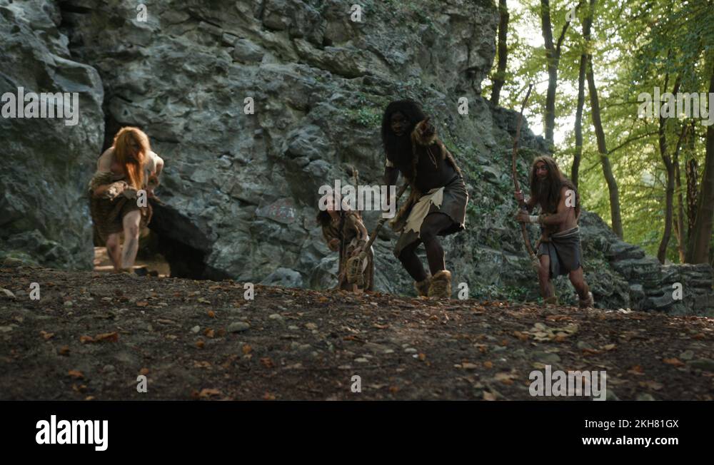 Primitive wild family of neanderthals hunting in the forest. African ...