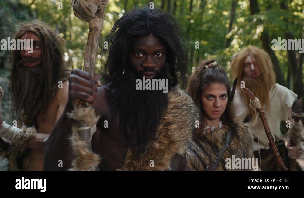 Wild primeval people of prehistoric multi-race tribe growling beating ...