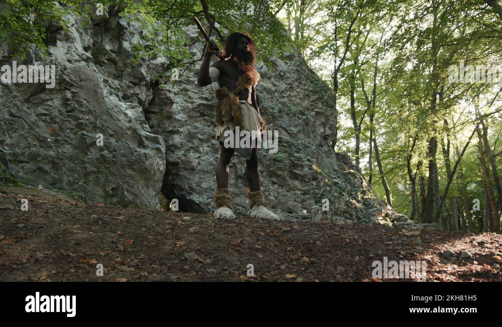 African neanderthal of ancient hunter-gatherers tribe standing outside ...