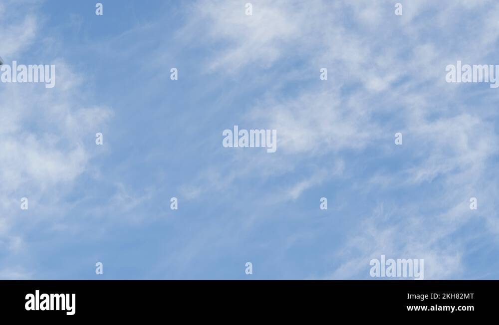 Qantas Airbus A380 flies across a blue sky with thing clouds near ...