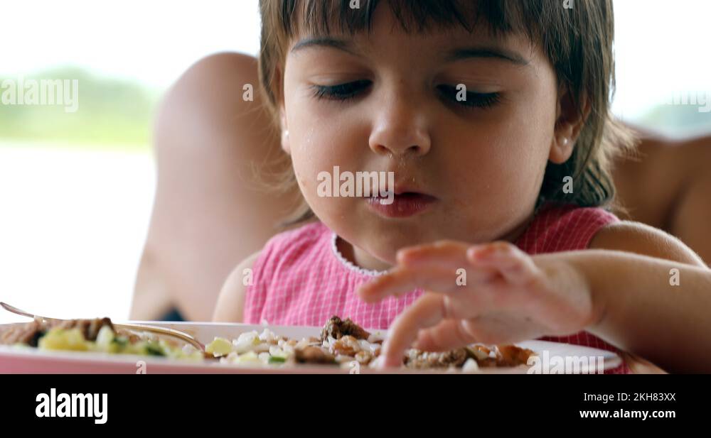 Little girl touching food eating with fingers Stock Video Footage - Alamy