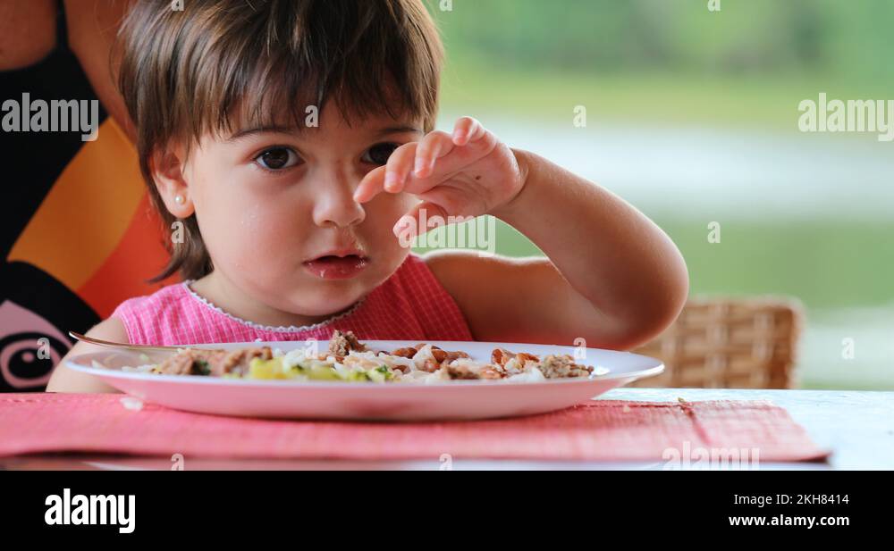 Little girl touching food eating with fingers Stock Video Footage - Alamy