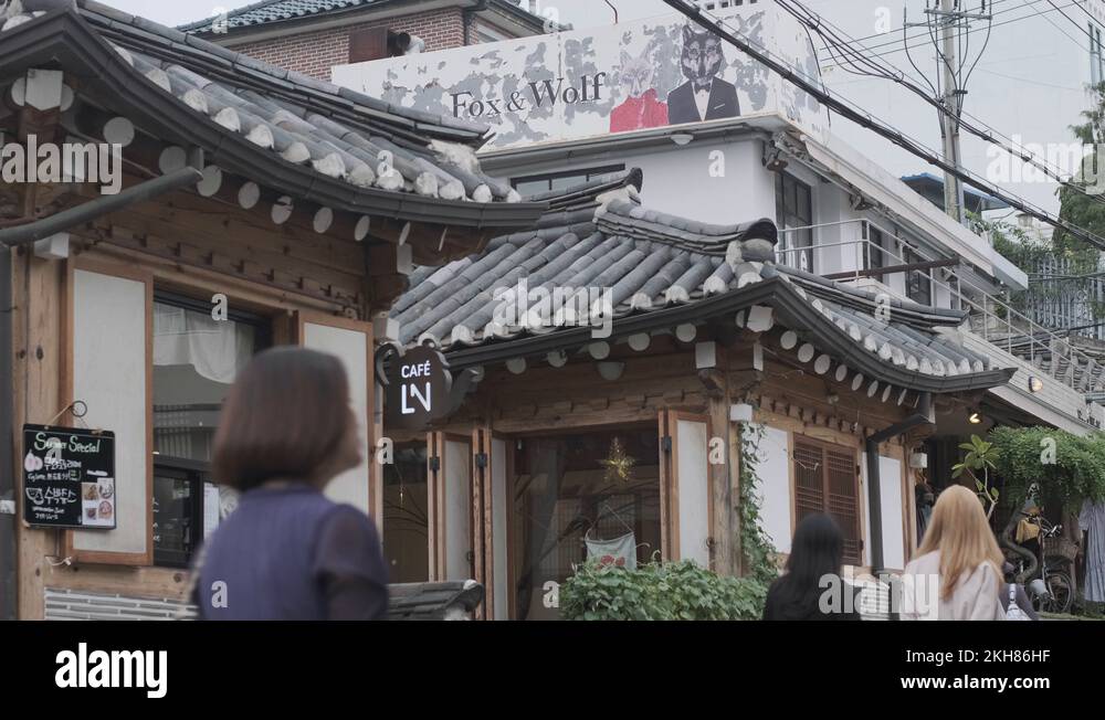 (Korea) Jongno 3ga : Koreans walk past shops in Korean traditional architecture Stock Video ...