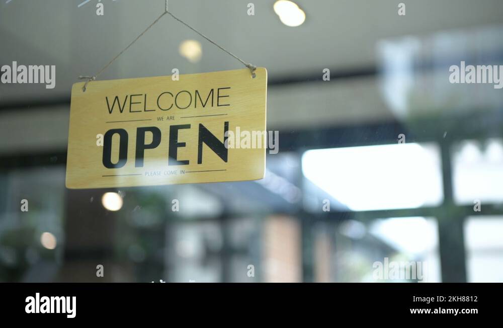 Coffee shop concept. A female employee is rolling over the coffee shop ...
