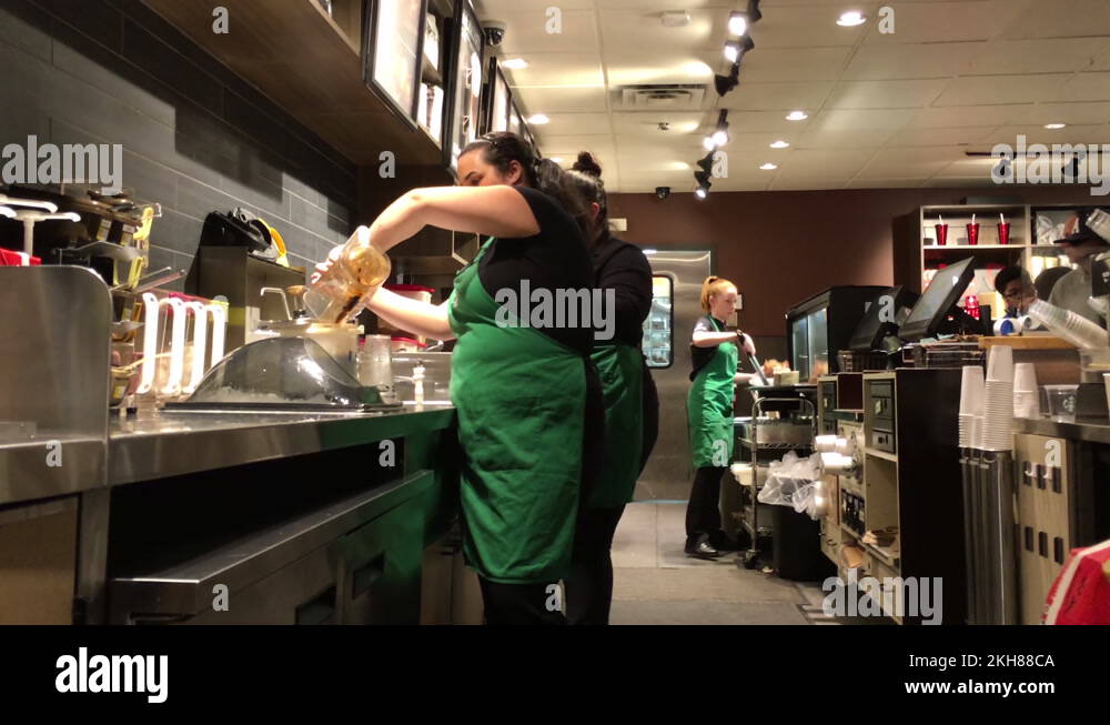 Motion of barista making coffee for the customer at Starbucks store ...