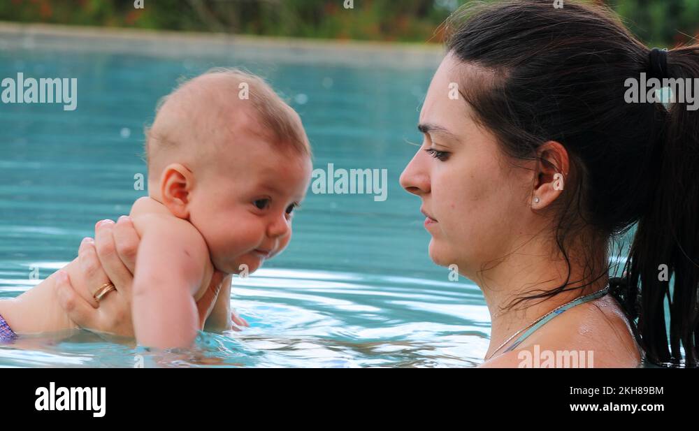 Mother and baby interaction at the swimming pool eskimo kiss Stock ...