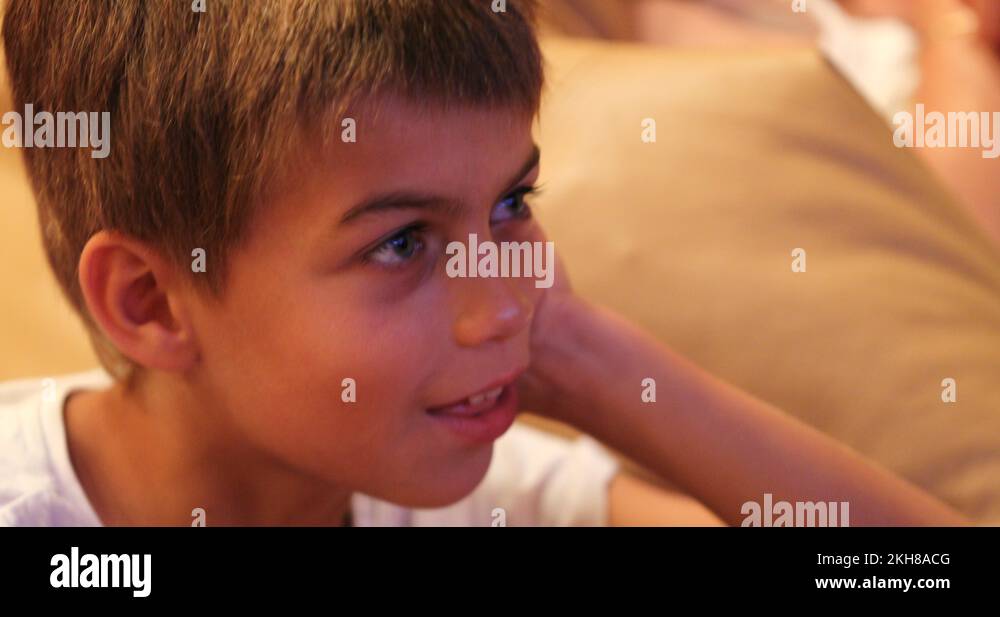 Candid real life child reaction watching movie screen TV at home kid ...