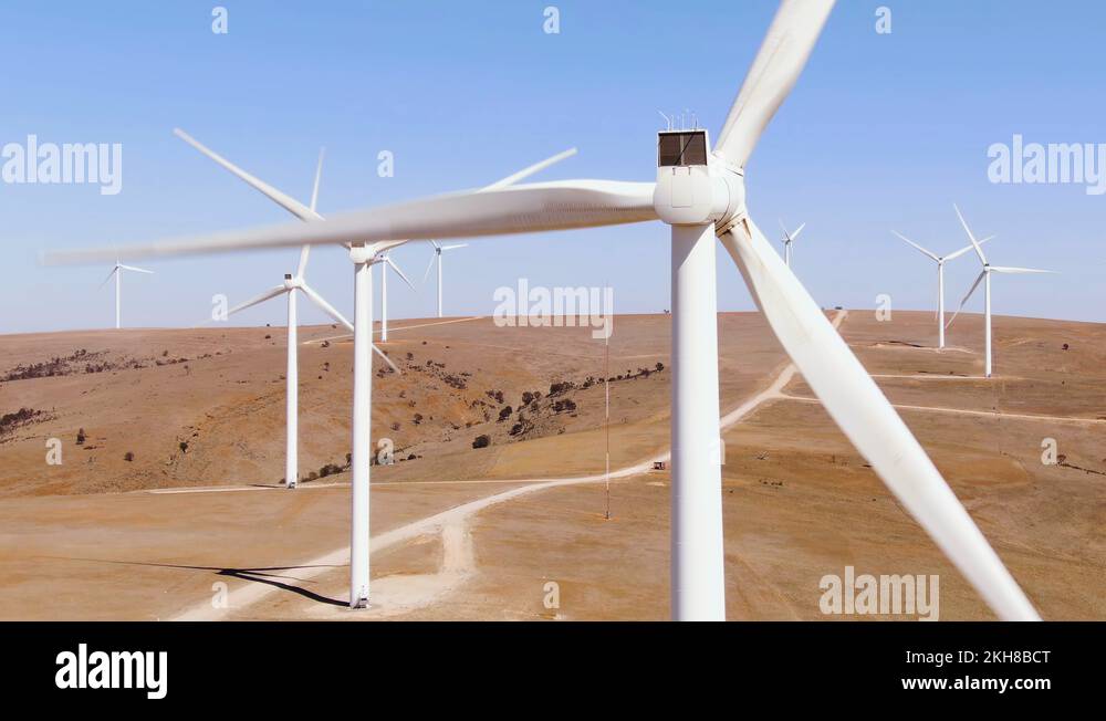 Aerial: various views of large wind turbines in rural areas with high ...