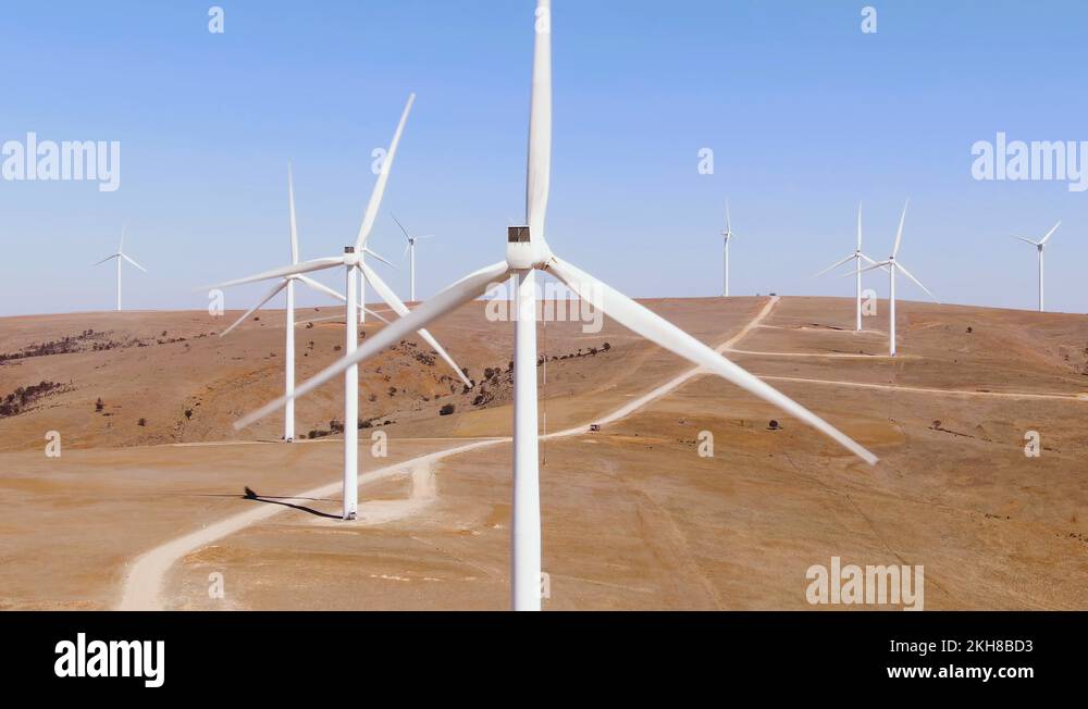 Aerial: various views of large wind turbines in rural areas with high ...