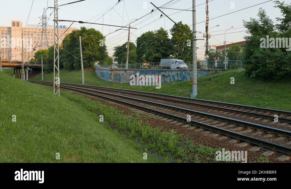 Aeroexpress high-speed train exits from under the bridge at low speed ...