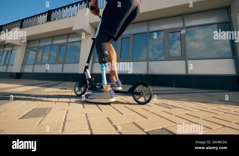 Athlete with a prosthetic leg is riding a scooter Stock Video Footage ...