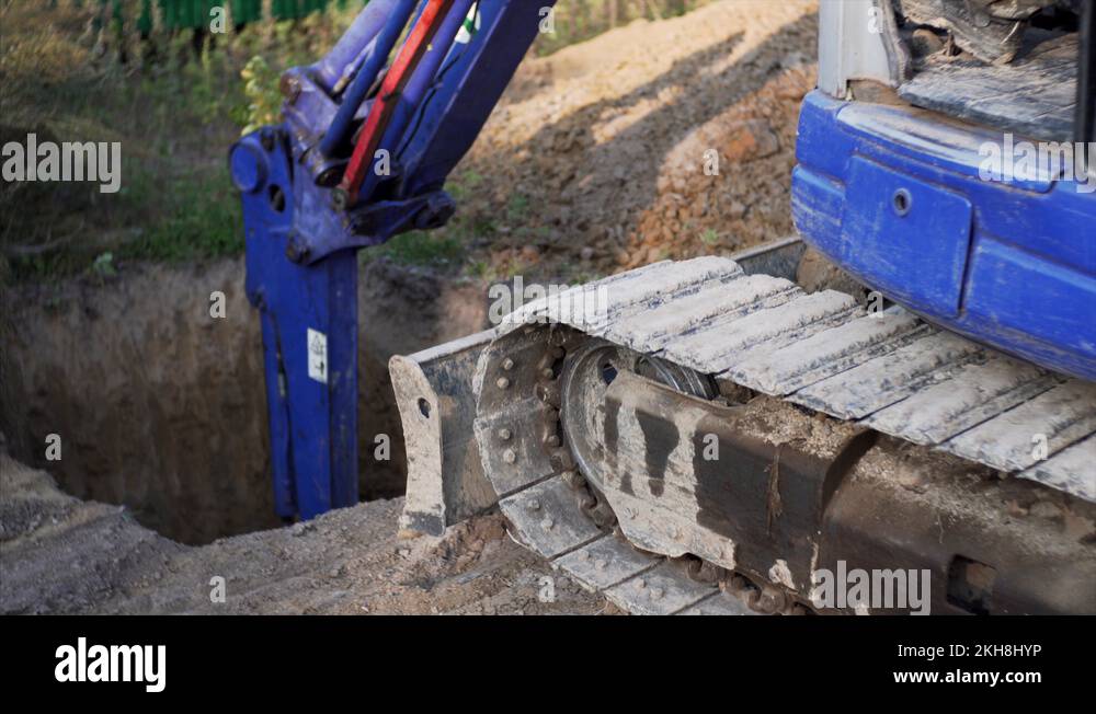 Excavator tracks are boosting a little because of stony soil while ...