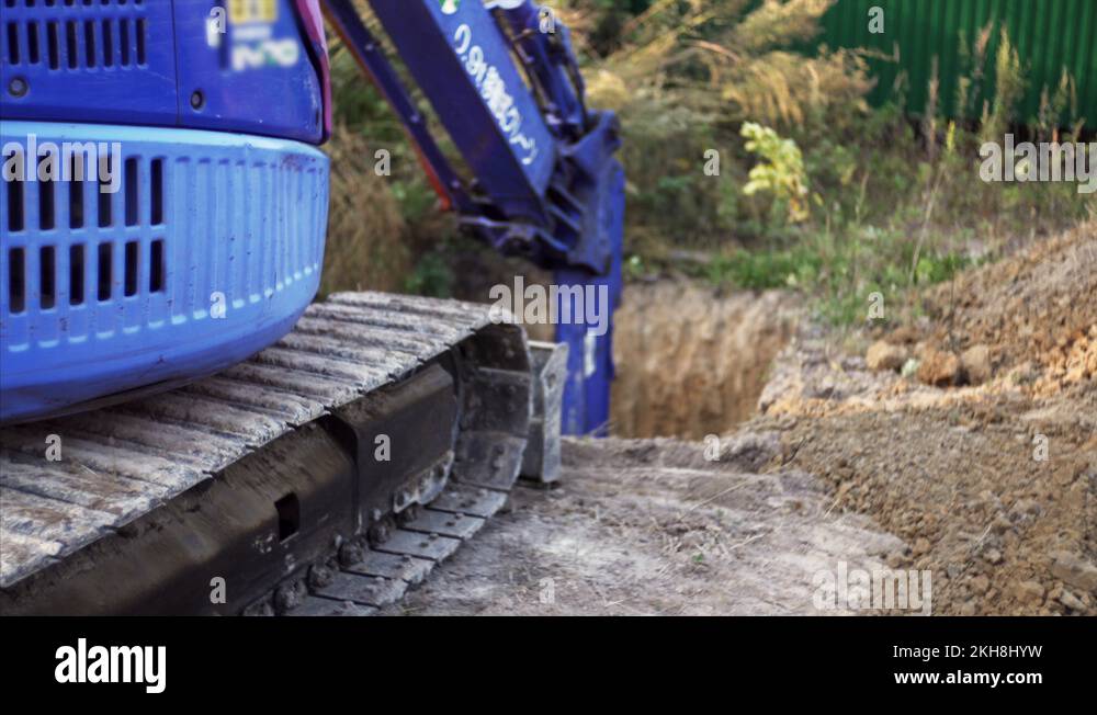 Excavator tracks are boosting a little because of stony soil while ...