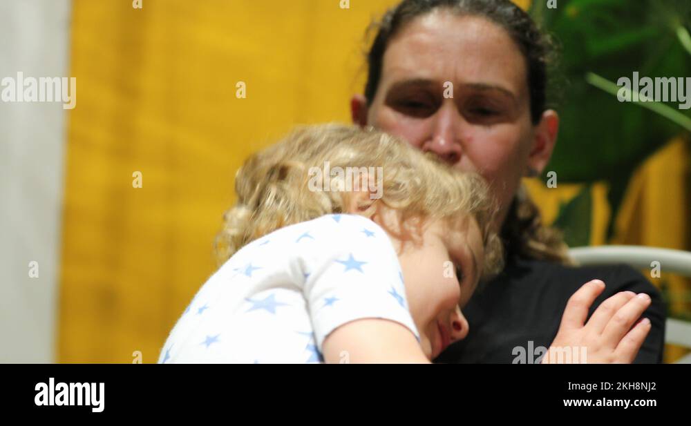 Toddler leaning to mother chest falling asleep candid and authentic ...