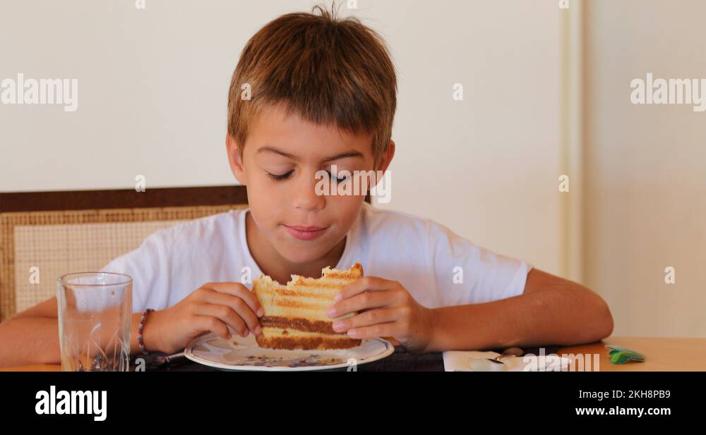 Child eating sandwich handsome young boy taking a bite of his ham and ...