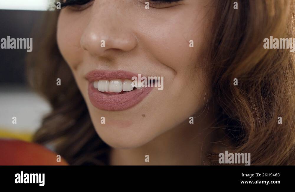 Beautiful happy exuberant lady biting red juicy apple by healthy teeth ...