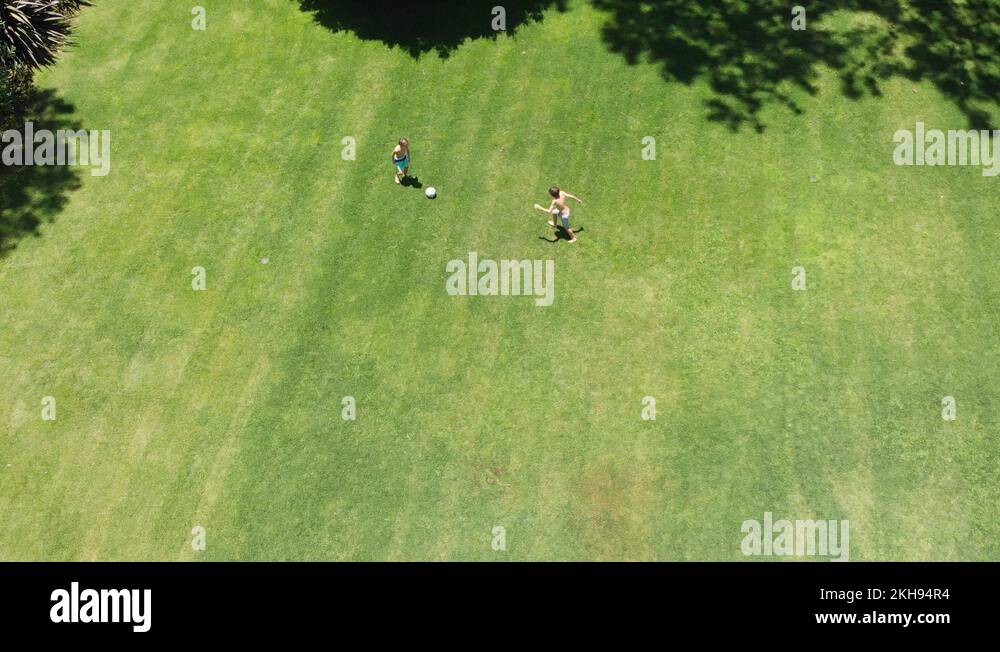 Children playing soccer, aerial vertical perspective of kids playing ...
