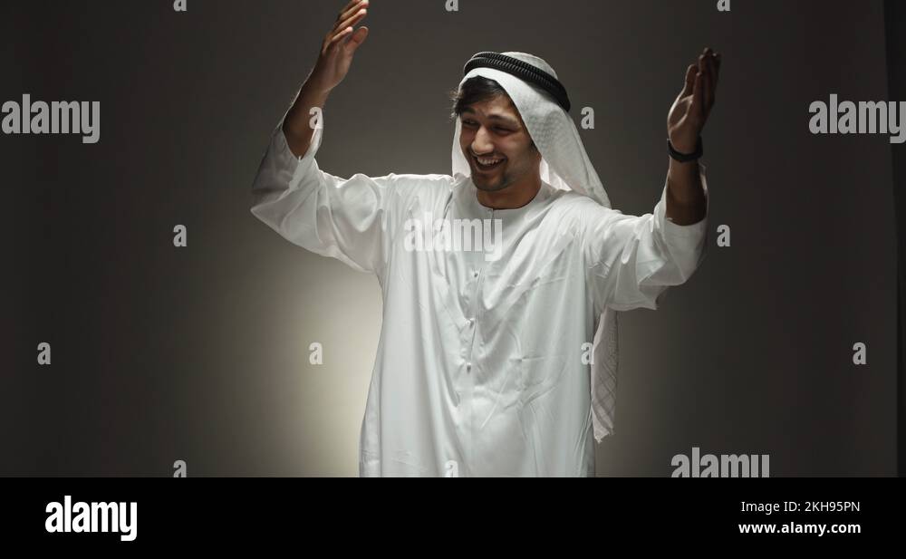 Bearded arab man dancing in front of camera. looking at it and ...