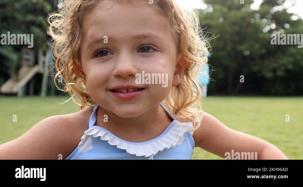 Pretty little girl posing and smiling Stock Video Footage - Alamy