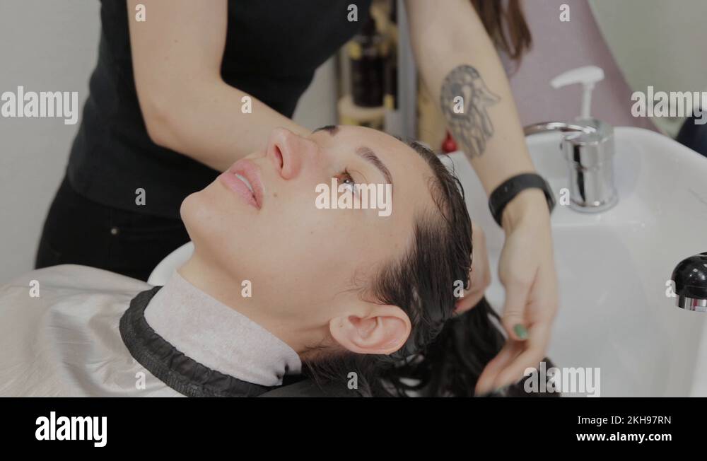 Beautiful young girl wash their hair at the hairdresser Stock Video ...