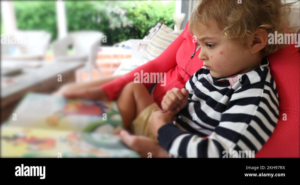 Mother reading story to her child. Mother telling storytelling to ...