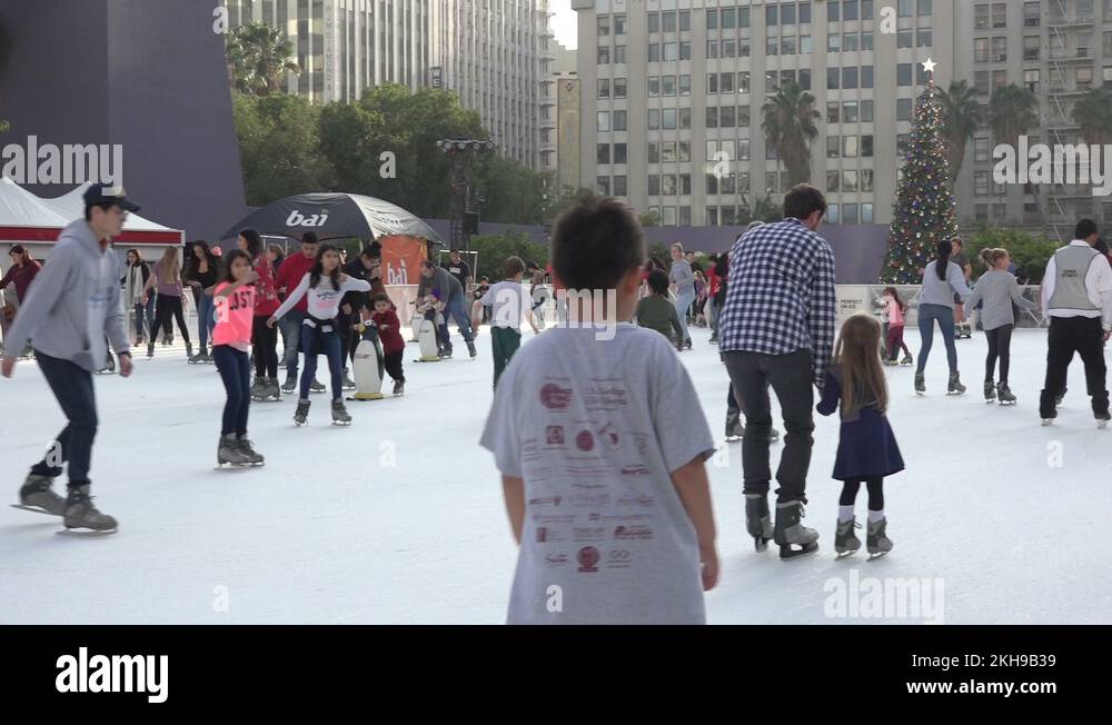 People enjoying the ice skating rink at Pershing Square in Los Angeles ...