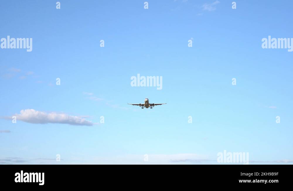 Modern passenger plane flies overhead, exactly in the center of the ...