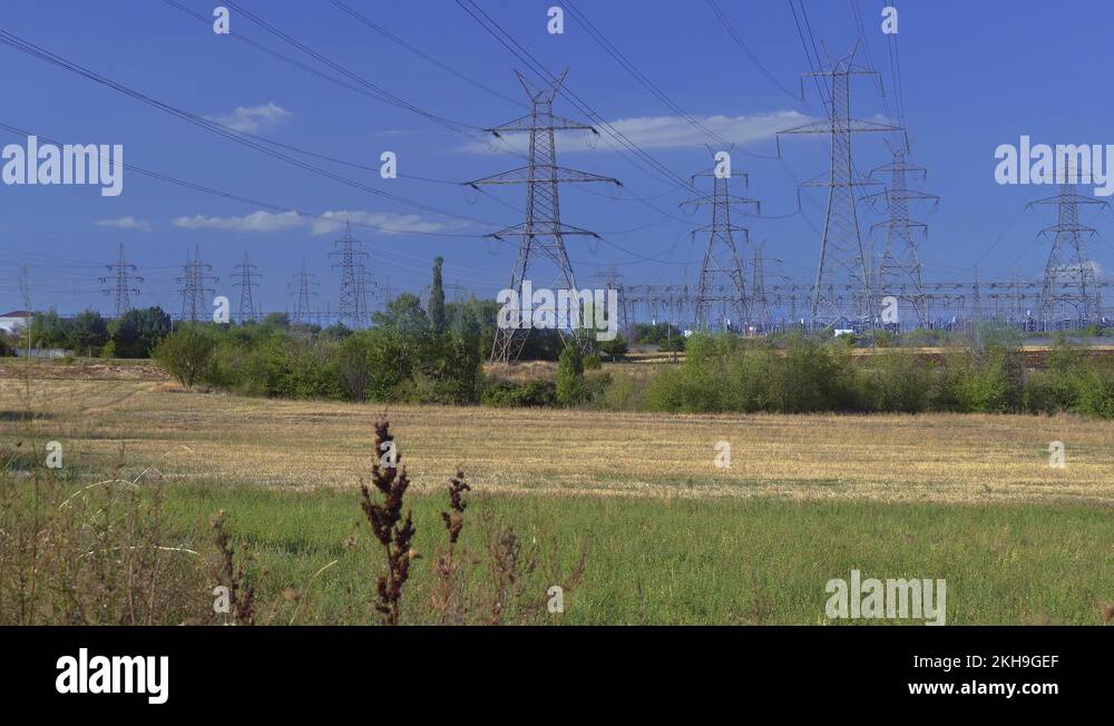 High voltage electric distribution lines on pylons at countryside Stock ...