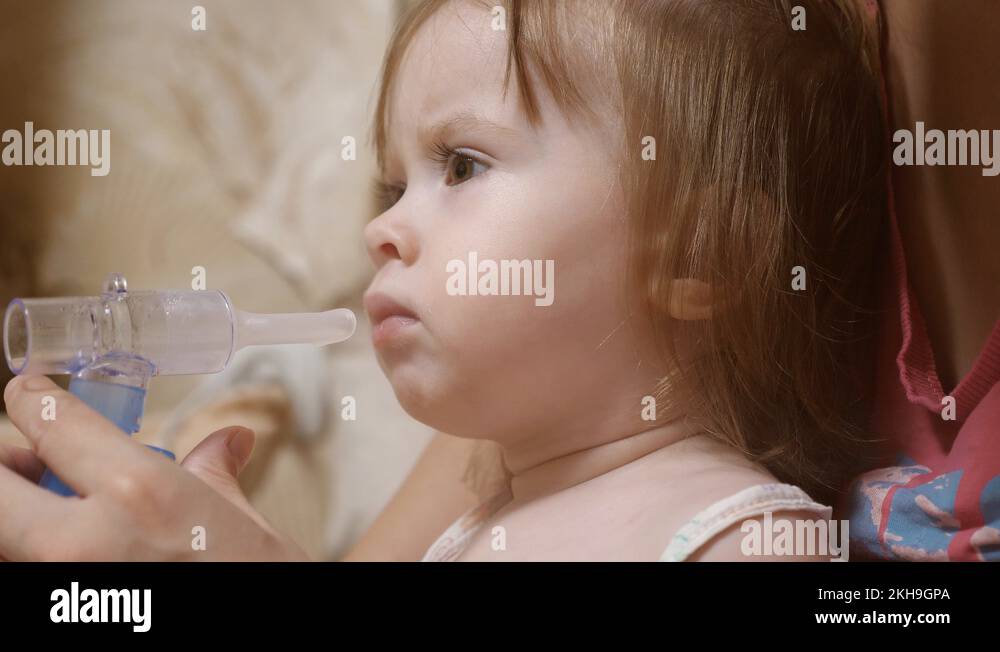 little girl treated with an inhalation mask on her face in a hospital ...