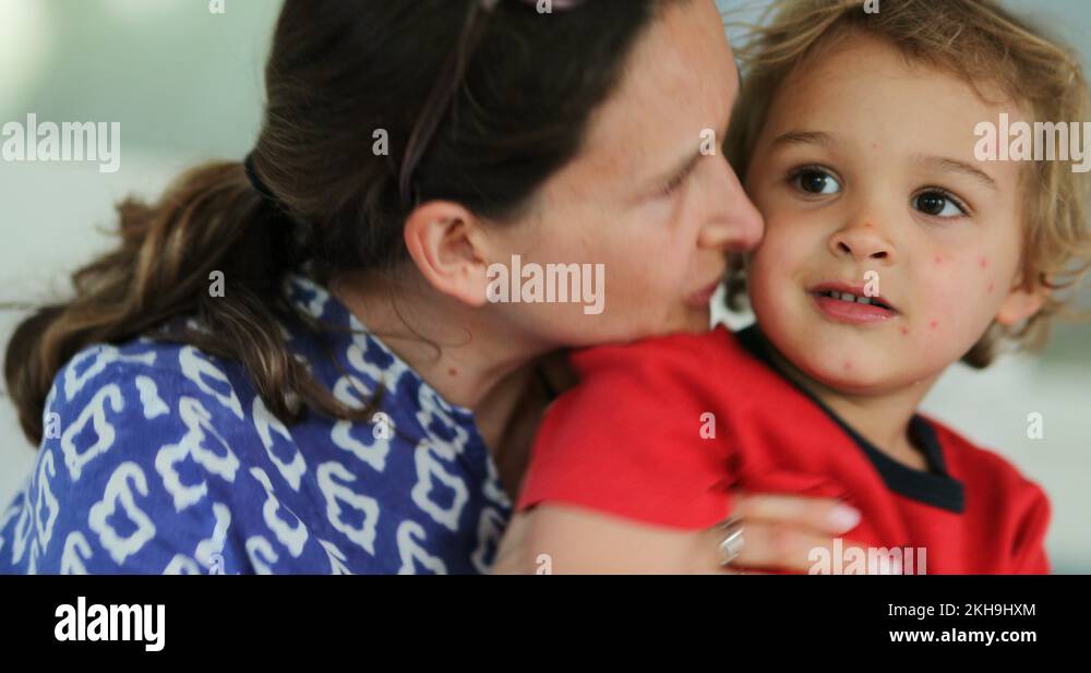 Mom holding baby toddler together. Mother kissing child, candid and real life Stock Video ...