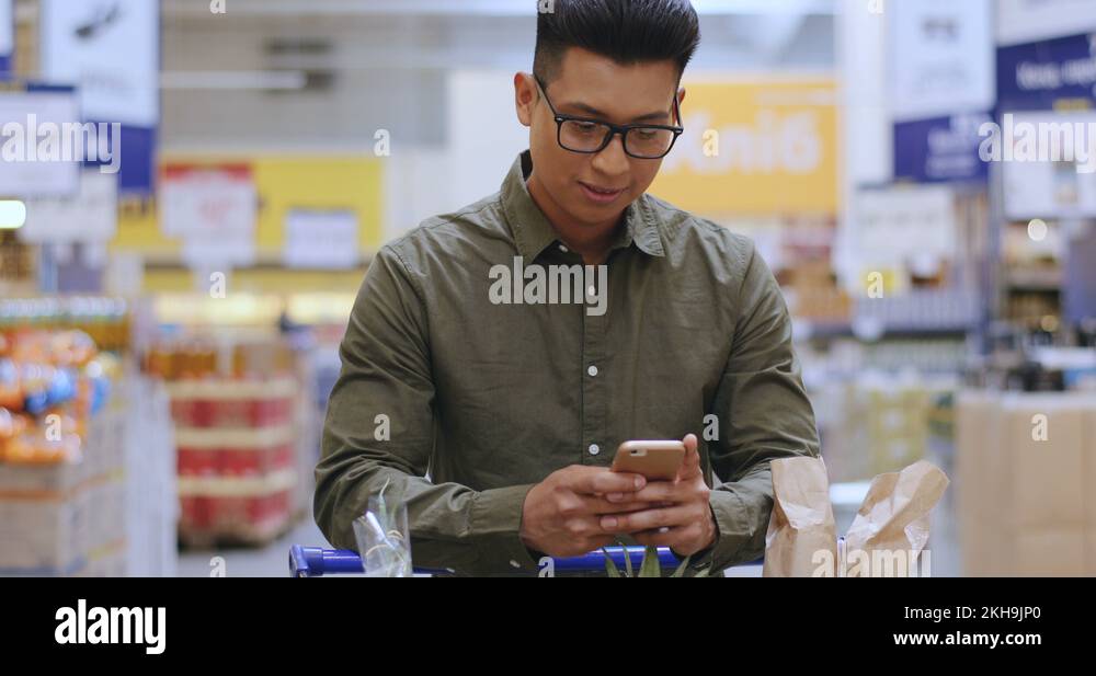 Asian young man tapping and typing while texting and chatting on the ...
