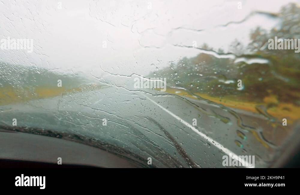 Heavy rain pouring during the road trip. POV of a passenger Stock Video ...