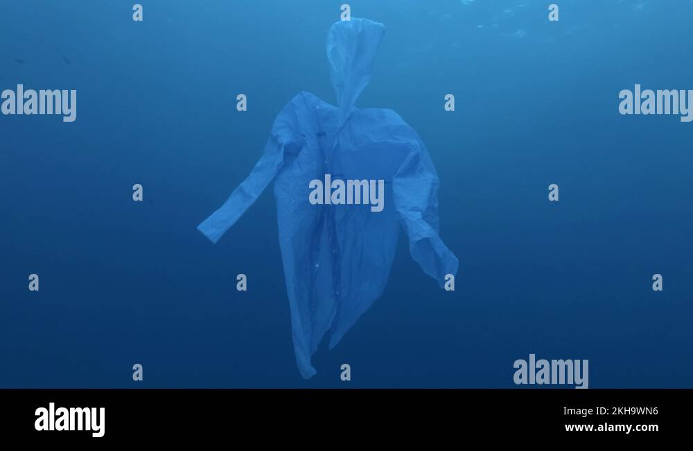 Blue plastic raincoat as a ghost float in the blue water. Plastic ...