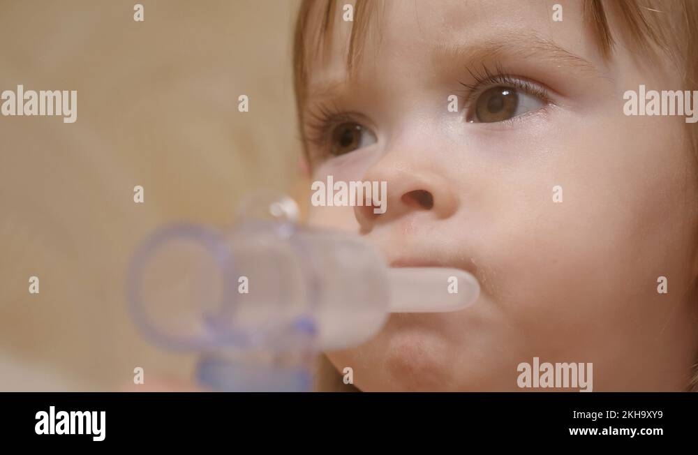 child is sick and breathes through an inhaler. Toddler treats flu by ...