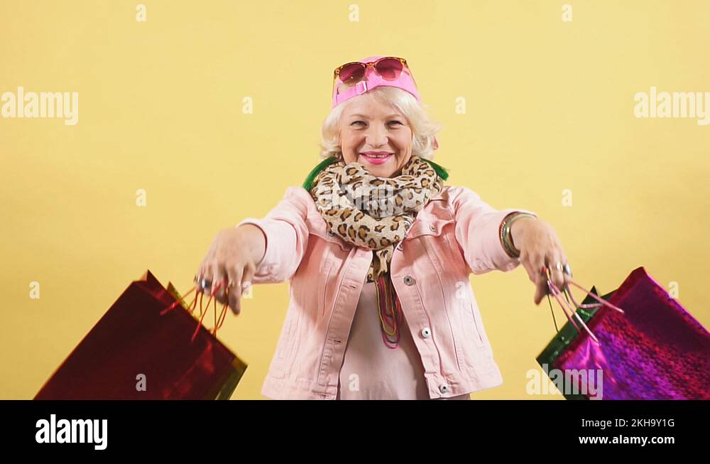 Pretty granny has bought presents, clothes for her granddaughters and ...