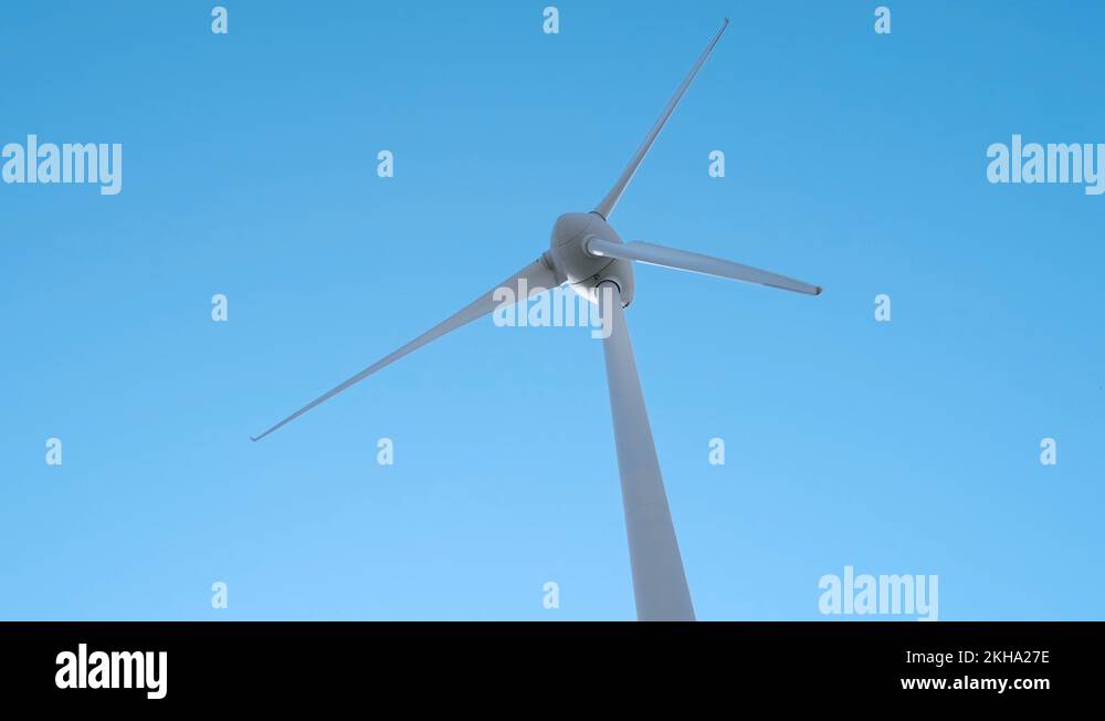 Slow motion of the blades of a large wind turbine in field a blue sky ...