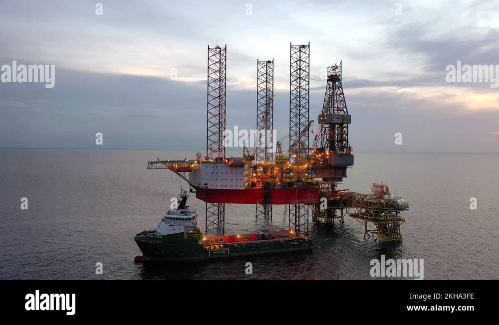Offshore jack-up drilling rig and a standby vessel Stock Video Footage ...