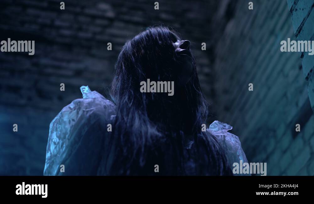 Evil witch screaming and saying spell to call spirits from hell for ...