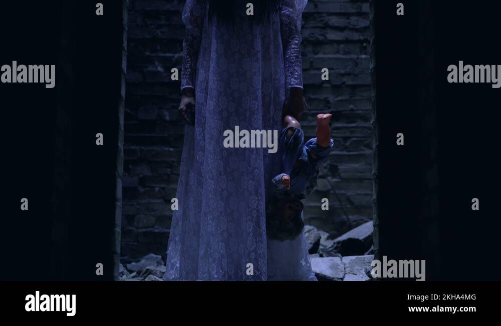 Scary bride ghost holding creepy doll in dark abandoned building ...